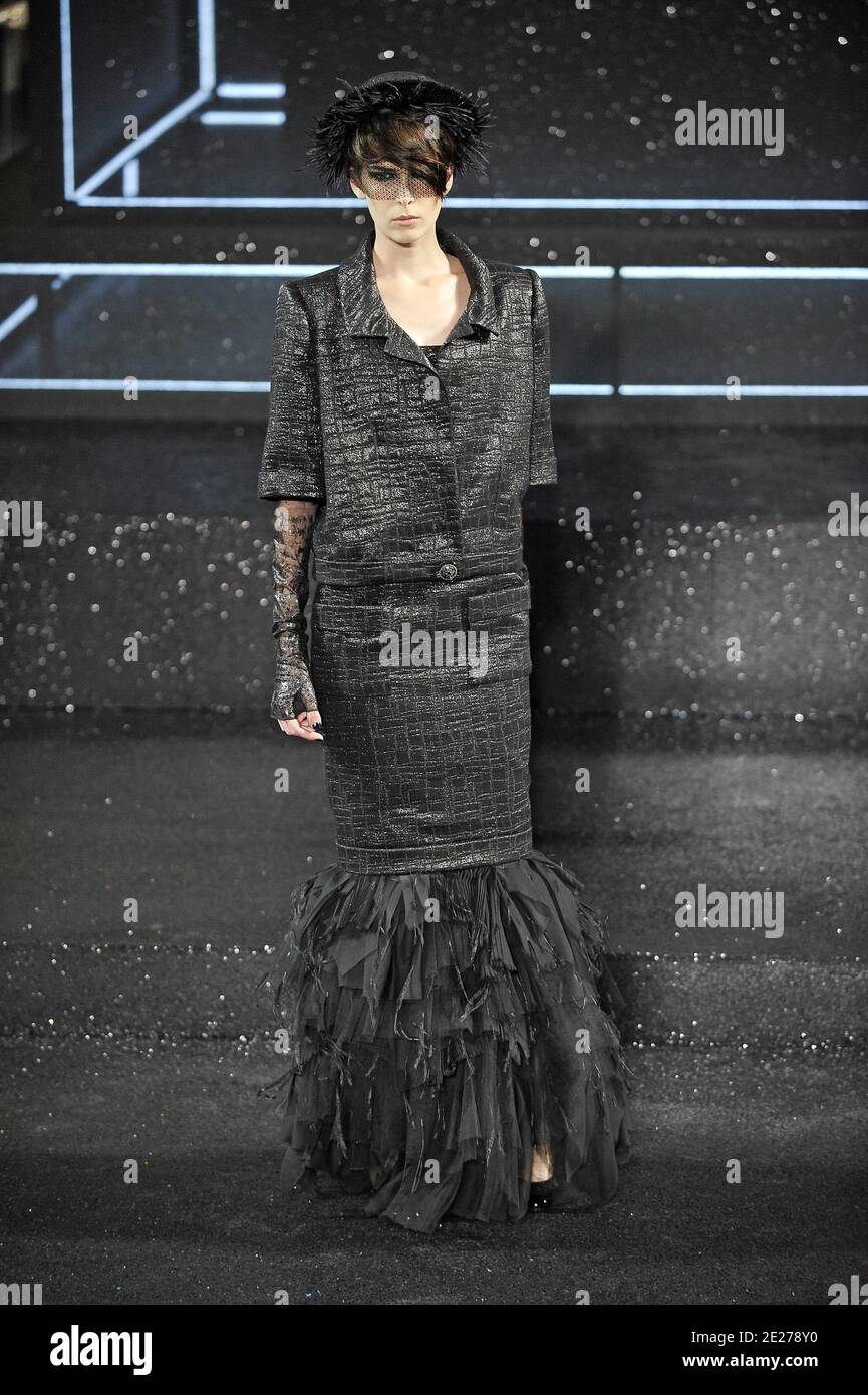 A model wears a creation designed by Karl Lagerfeld for Chanel Fall ...