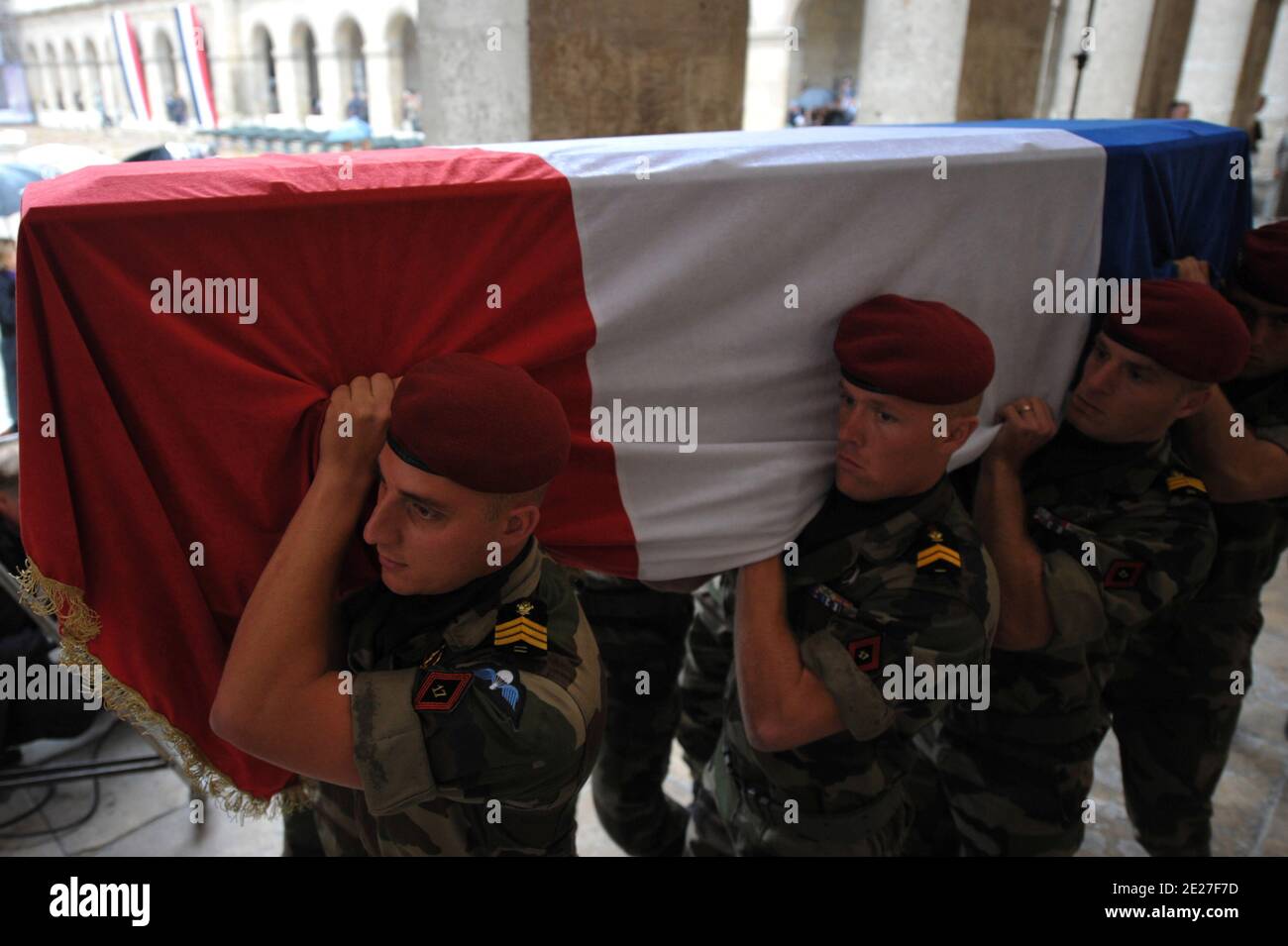 Flag-draped coffins are carried inside the church as France pays ...