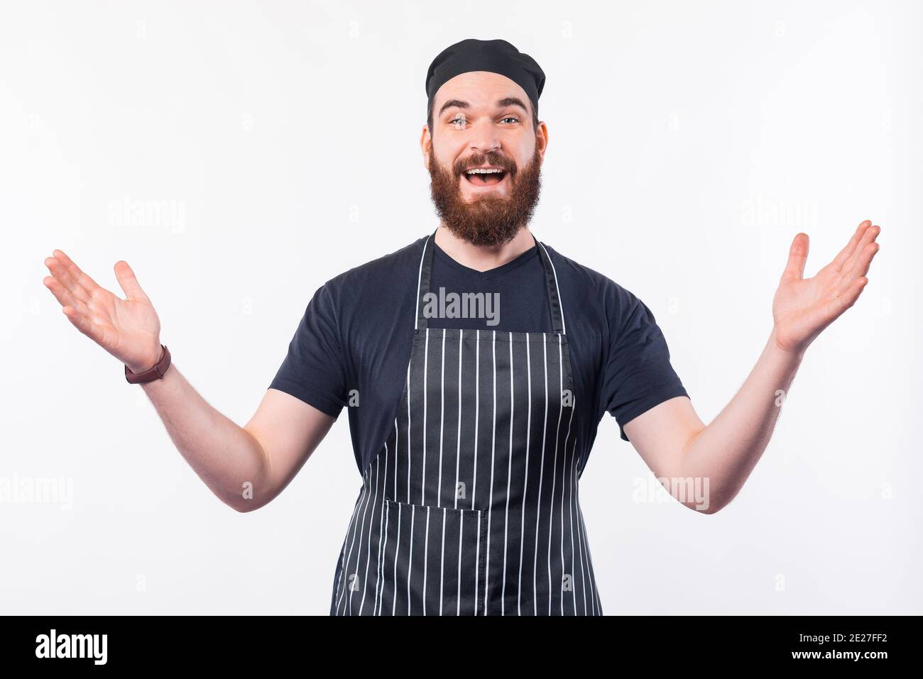Photo of cheerful Chef man with beard making welcome gesture Stock ...
