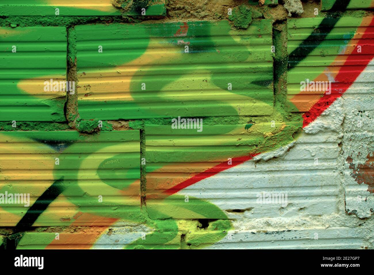 Striated pattern bricks with colorful graffiti Stock Photo - Alamy