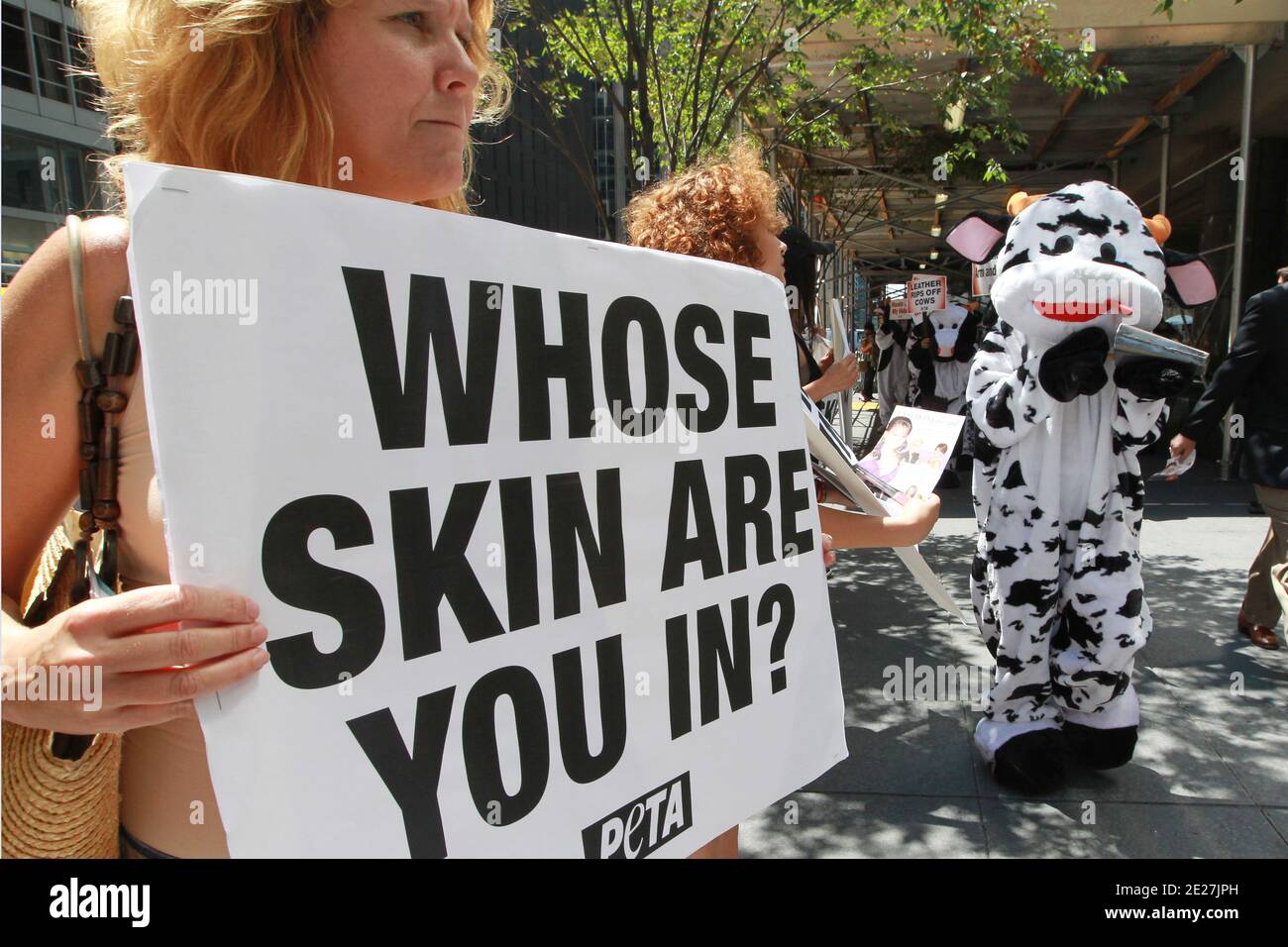 A herd of PETA members dressed in cow costumes protest leather goods in ...