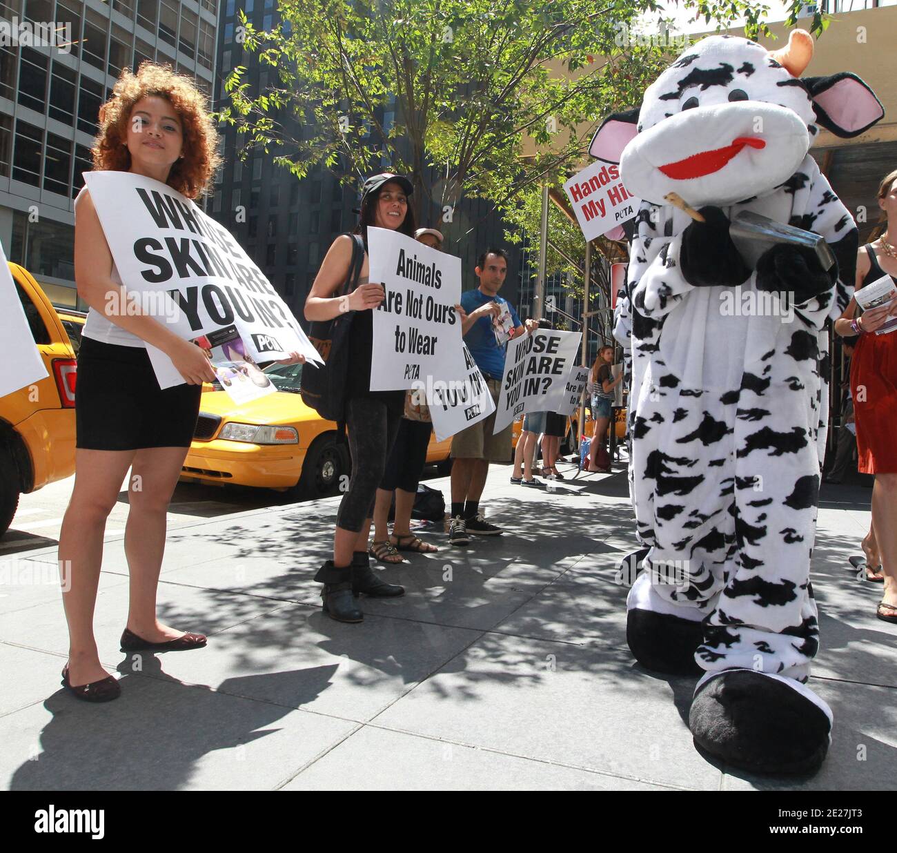 A herd of PETA members dressed in cow costumes protest leather goods in ...