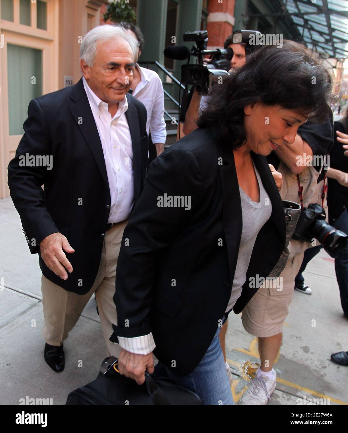 Dominique Strauss-Kahn and his wife Anne Sinclair leave their townhouse ...