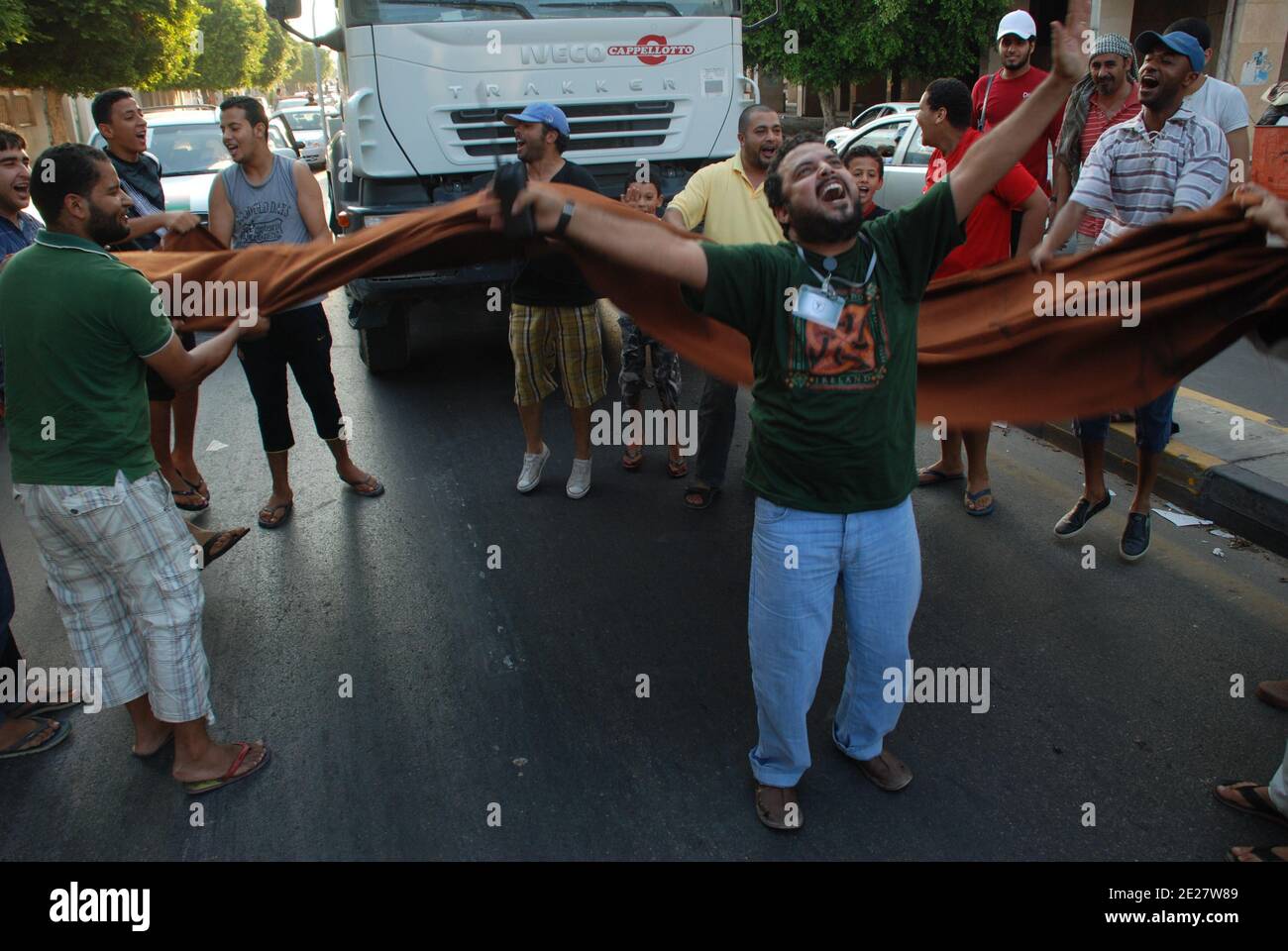 People dancing in the street around their leader Gaddafi's tribal alfit ...