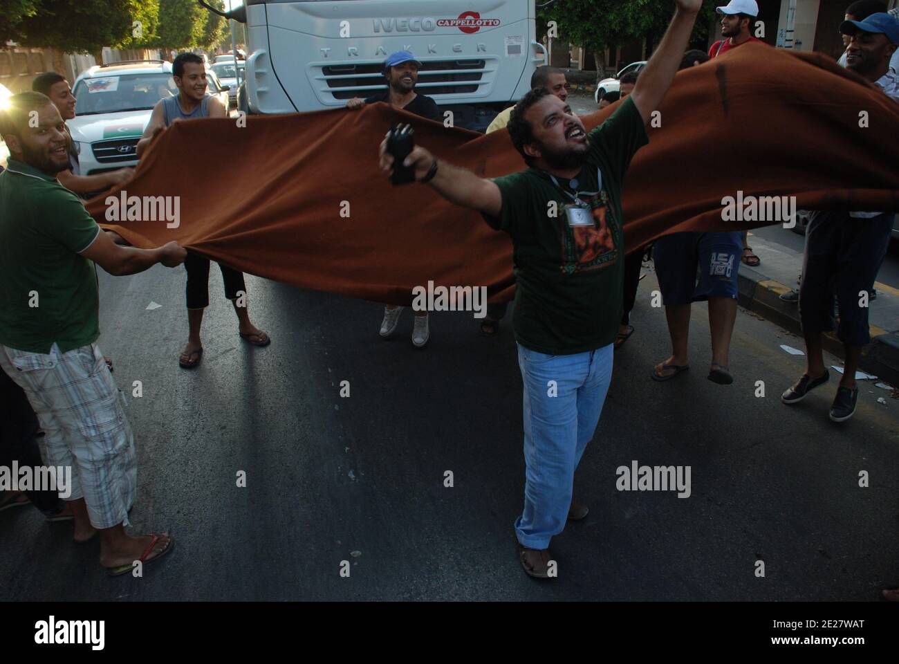 People dancing in the street around their leader Gaddafi's tribal alfit ...