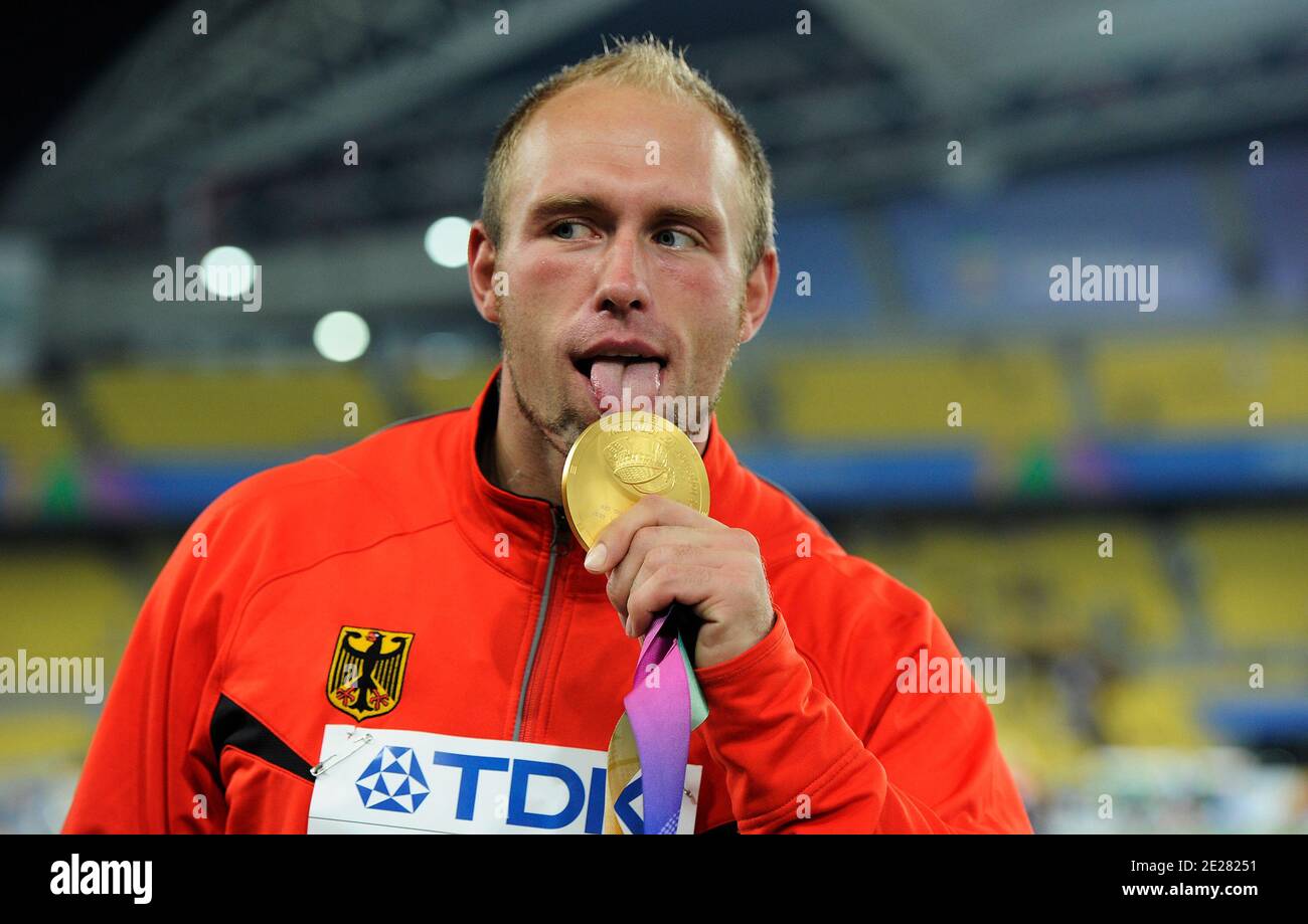 Robert Harting from Germany poses with the gold medal after his victory ...