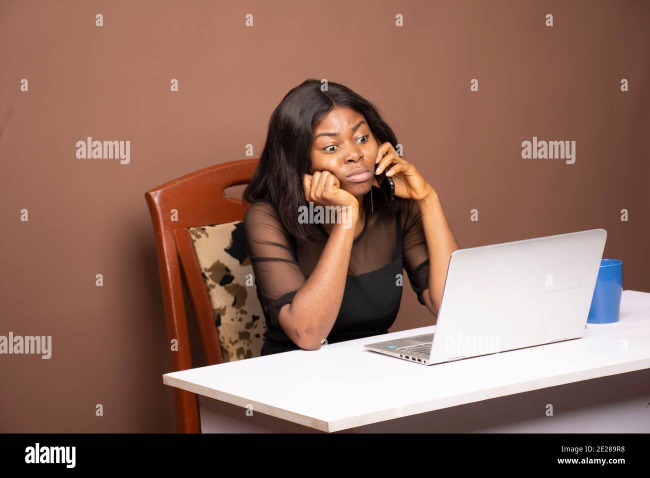 a young lady making a phone call in the office Stock Photo - Alamy