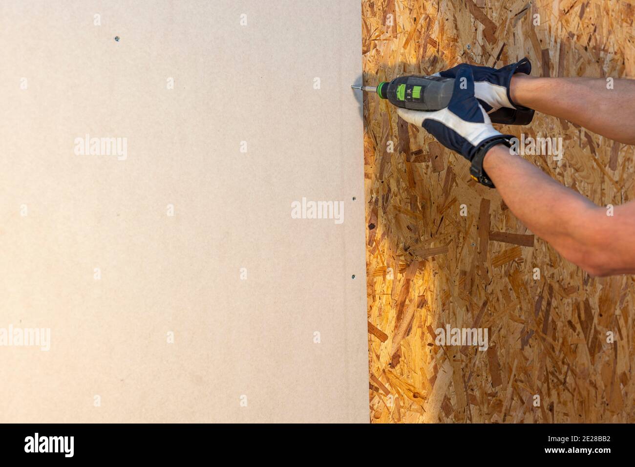 Close up view of male worker hands holding screwdriver. Construction ...