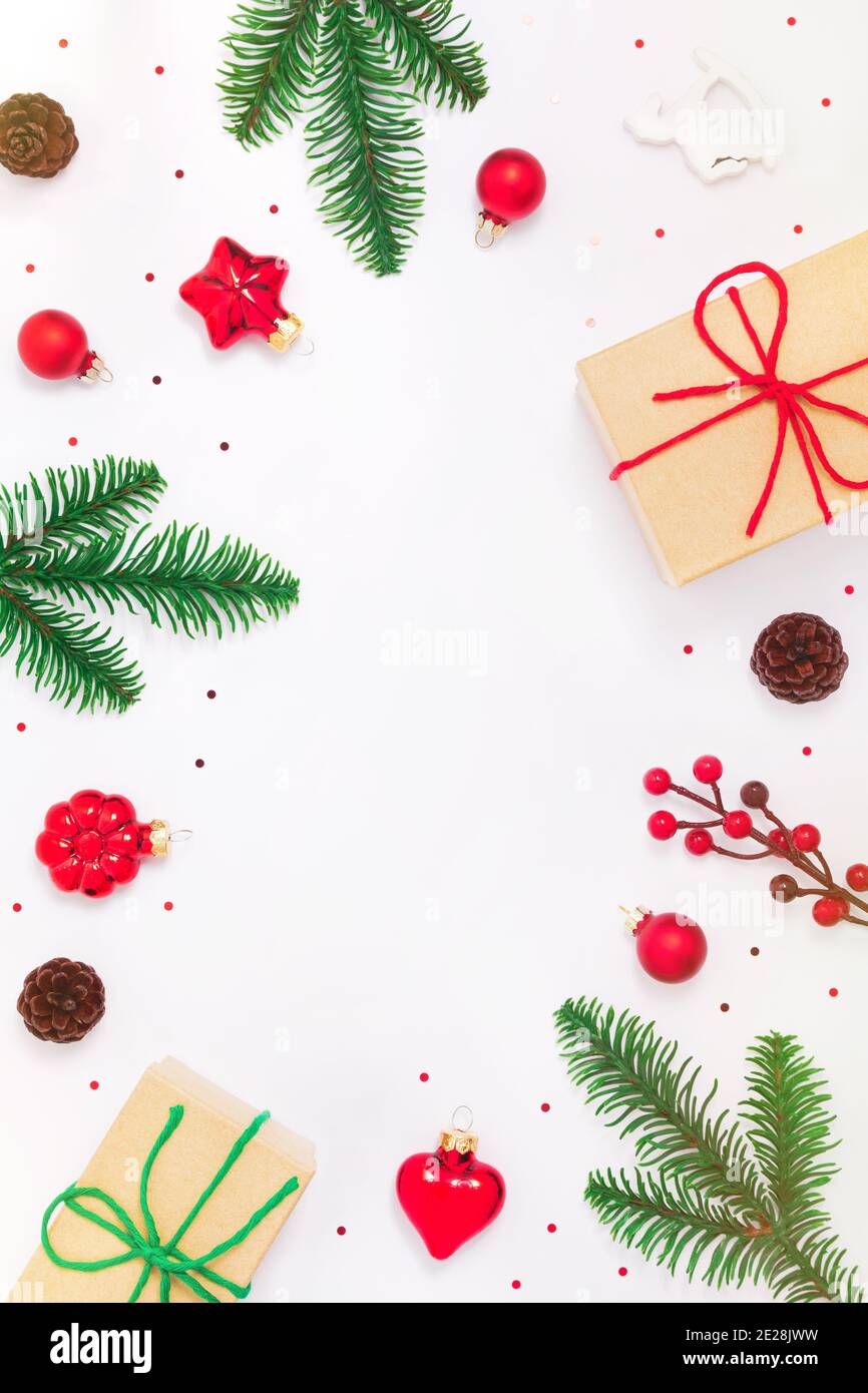 Christmas frame with present in craft paper, baubles, fir tree branches ...