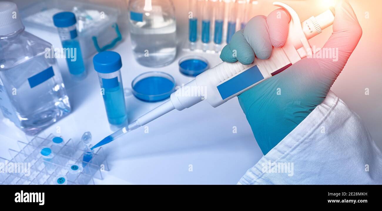 Hand in glove with automatic pipette and samples, panoramic image ...