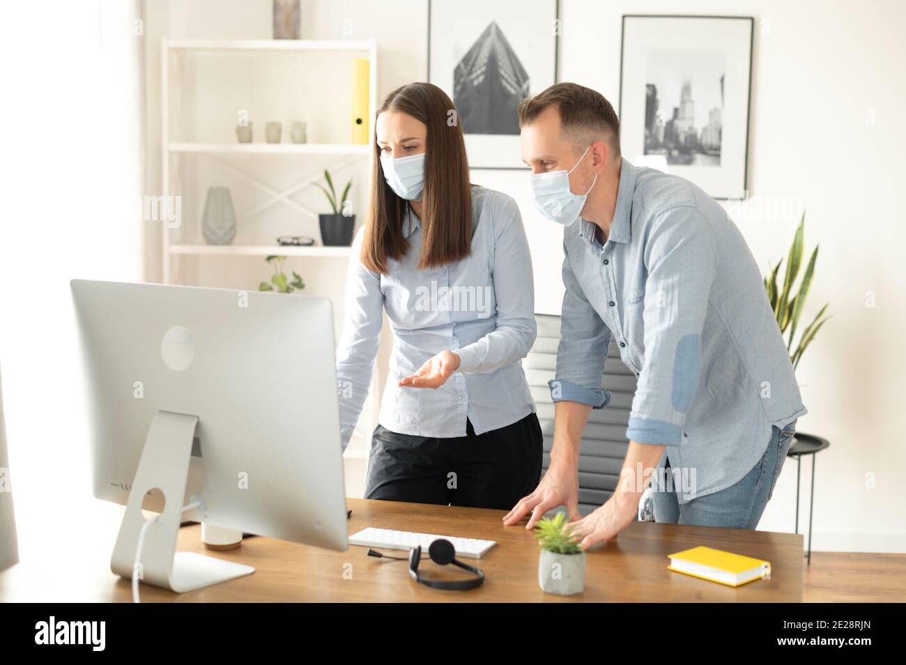 Office workers in medical masks in the office Stock Photo - Alamy