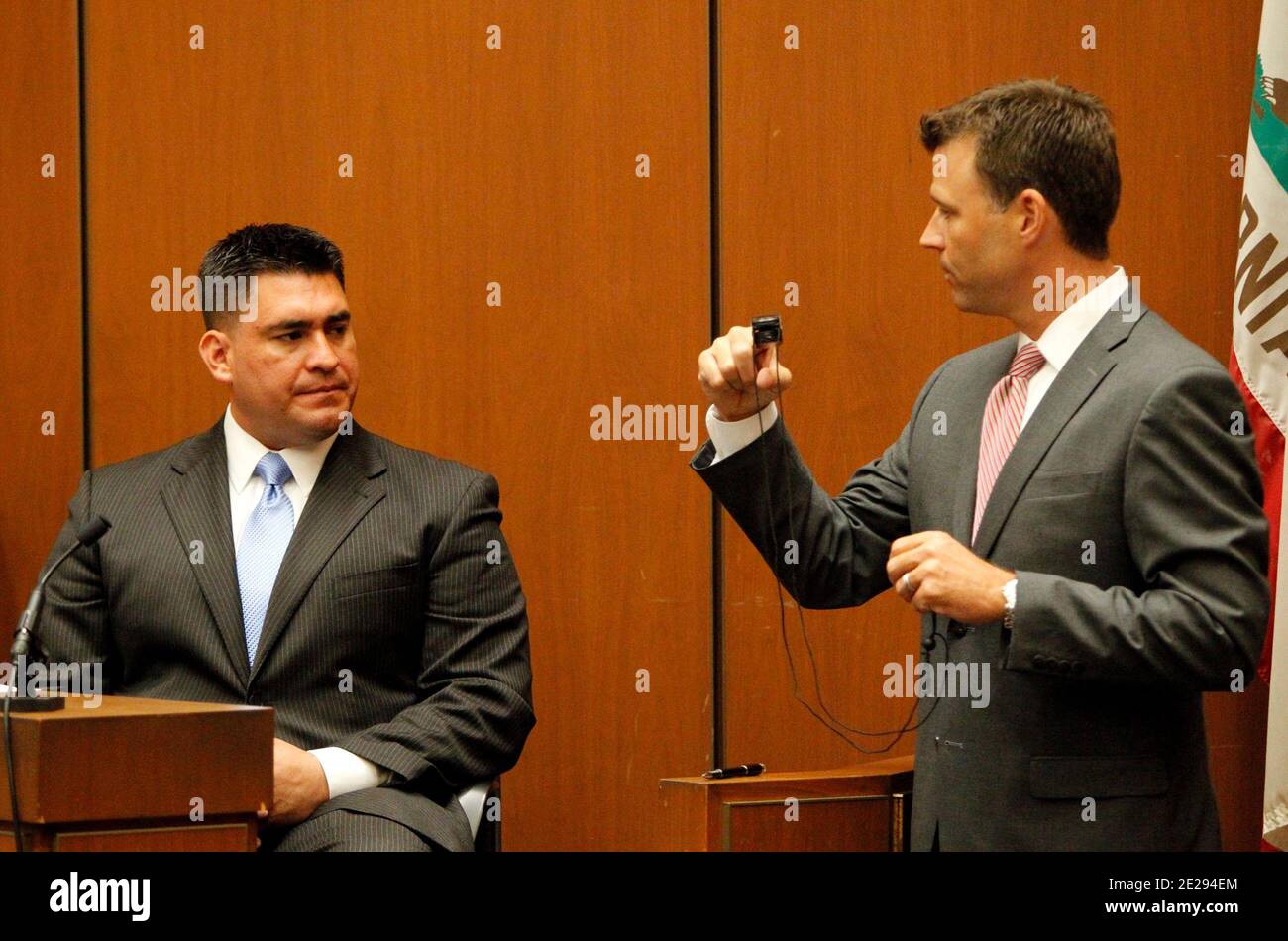 Deputy District. Attorney. David Walgren, holding a monitoring device ...