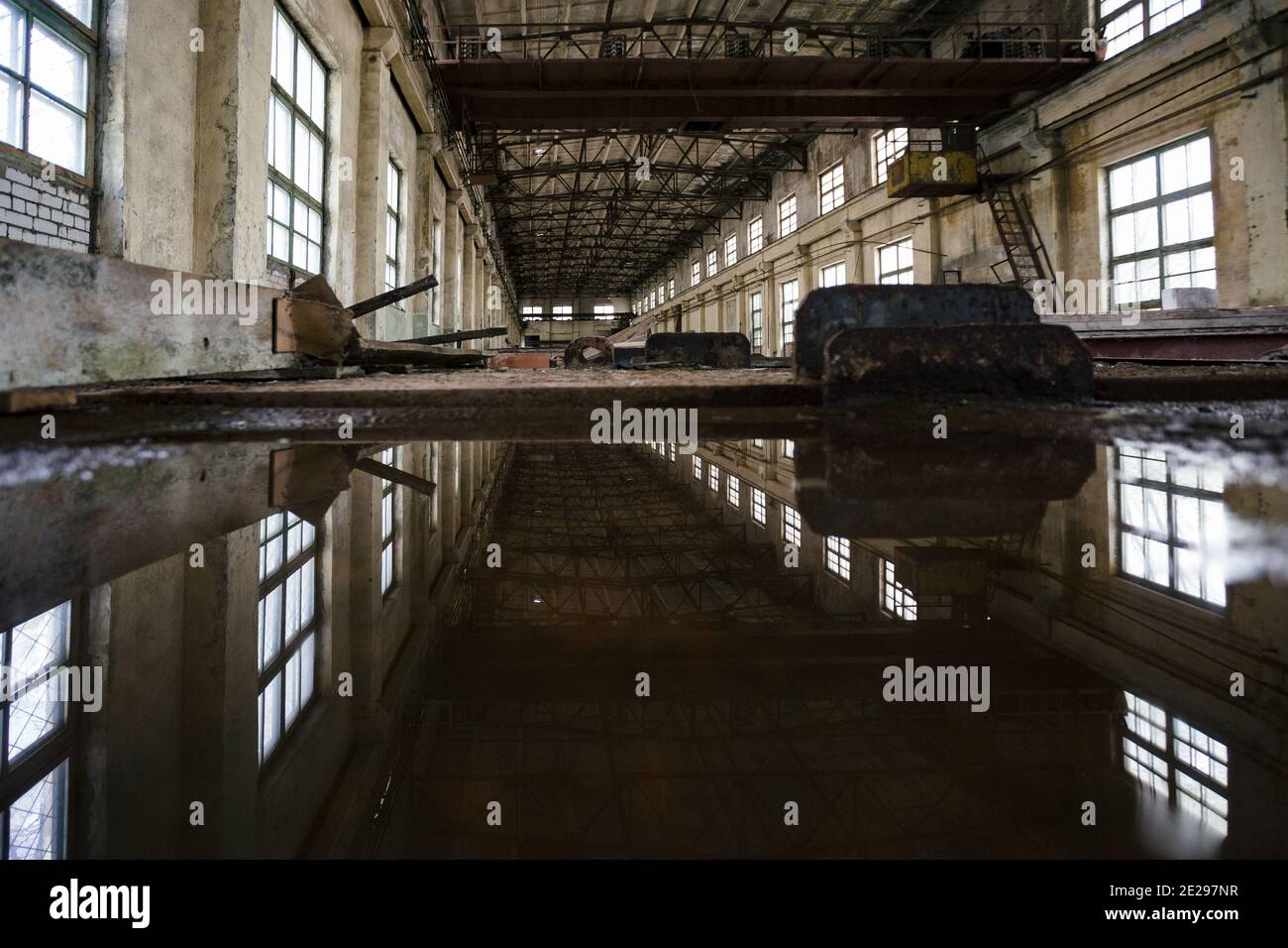 Inside of flooded dirty abandoned ruined industrial building with water ...