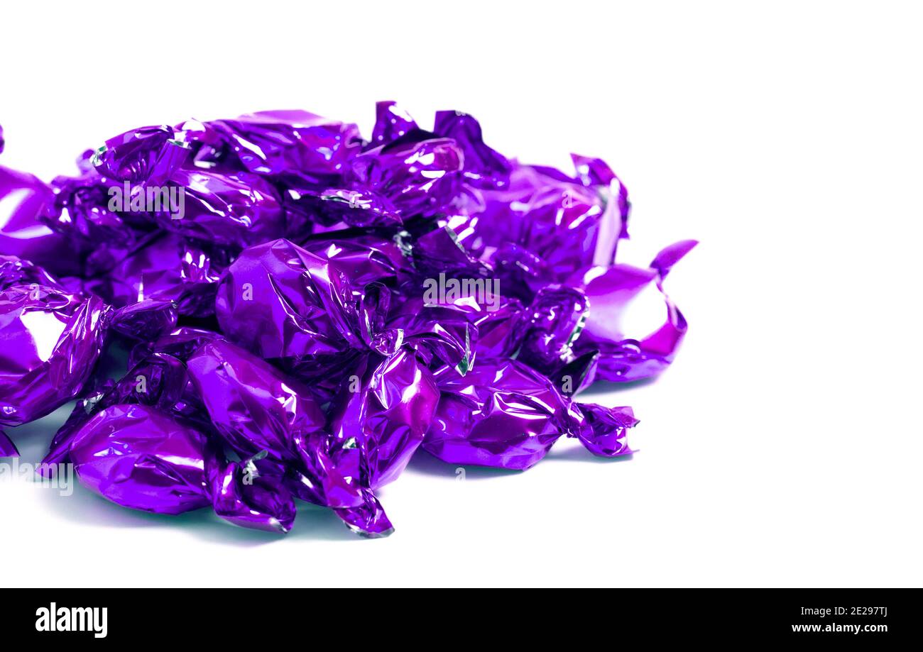 A Pile of Purple Wrapped Candy Isolated on a White Background Stock ...