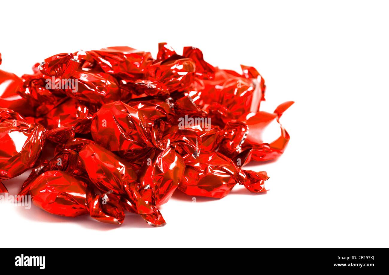 A Pile of Red Wrapped Candy Isolated on a White Background Stock Photo ...