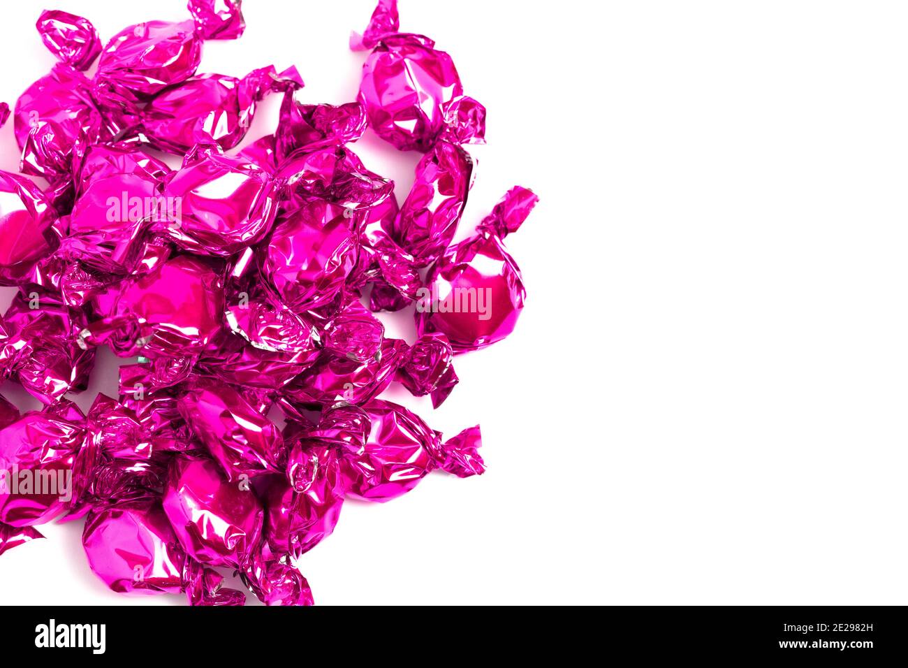 A Pile of Pink Wrapped Candy Isolated on a White Background Stock Photo ...