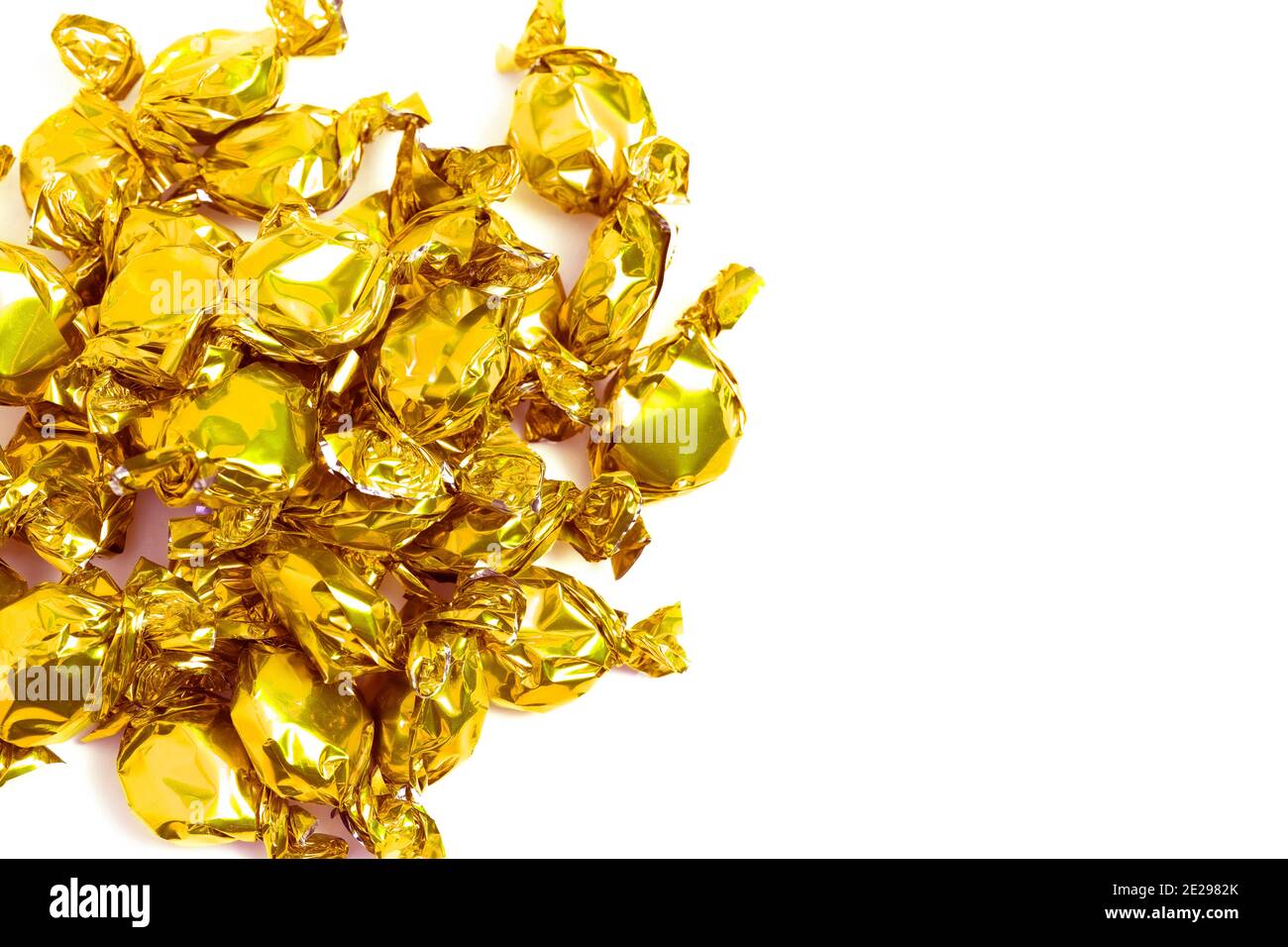 A Pile of Golden Wrapped Candy Isolated on a White Background Stock ...