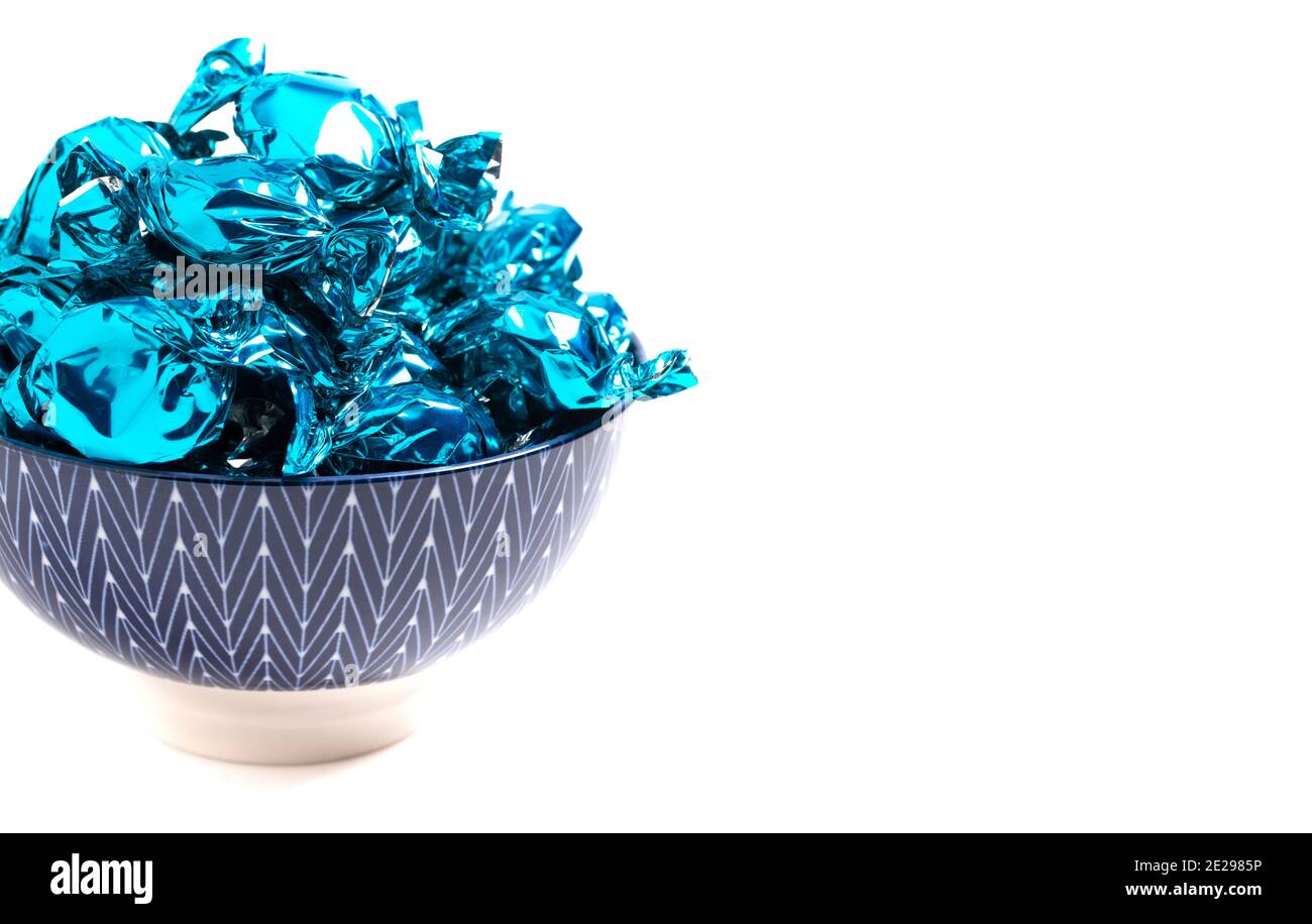 A Bowl of Blue Wrapped Candy Isolated on a White Background Stock Photo ...