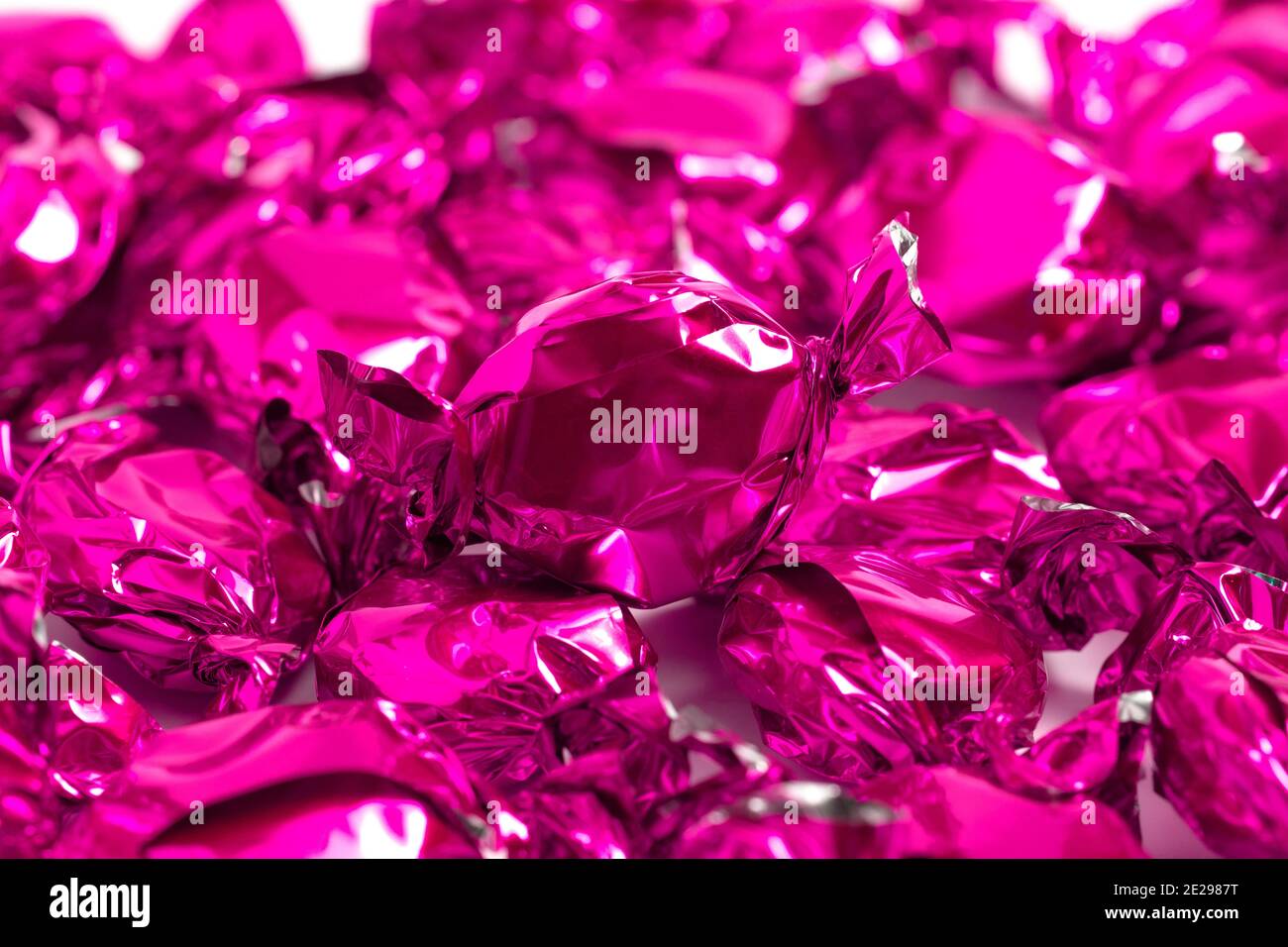A Background of Pink Wrapped Candy Stock Photo - Alamy