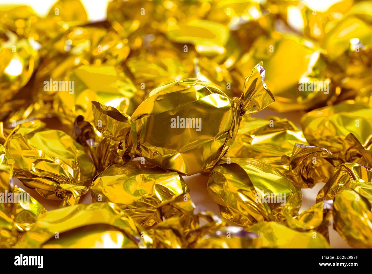 A Background of Golden Wrapped Candy Stock Photo - Alamy