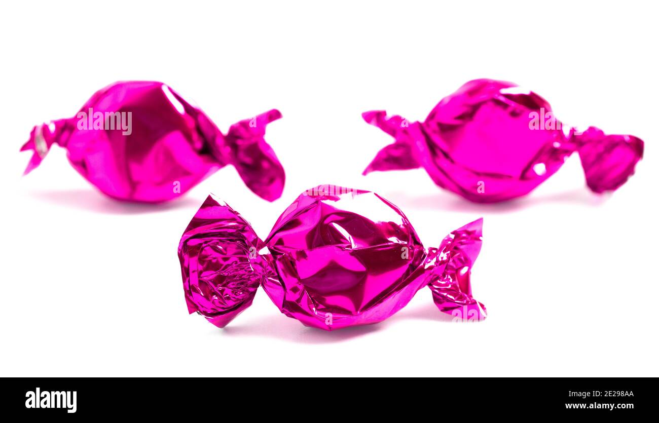 Three Pink Wrapped Candy Isolated on a White Background Stock Photo - Alamy