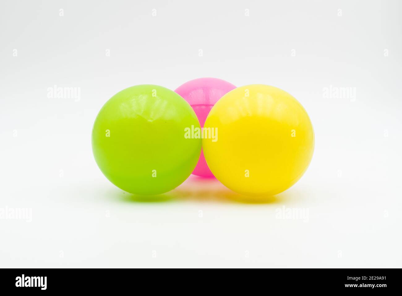 Closeup shot of three colorful plastic balls isolated on a white ...