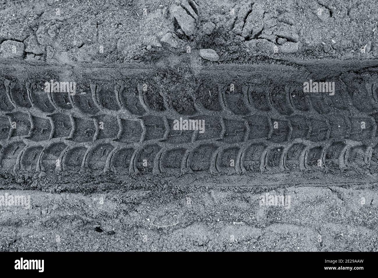 Top view shot of a tire track prints on the gray sand Stock Photo - Alamy