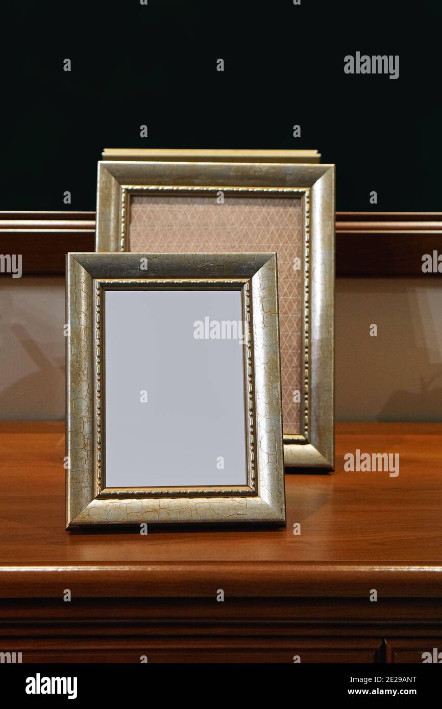 Gold picture frames at night table Stock Photo - Alamy