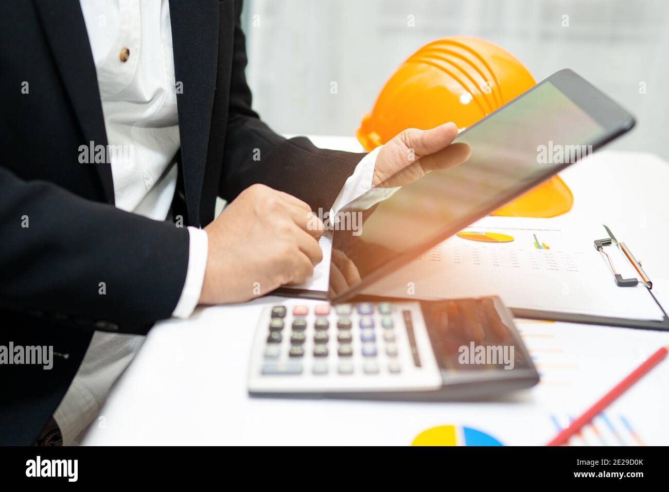 Architect or engineer working project accounting with graph and ...