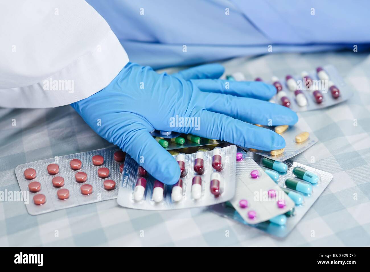 Asian doctor holding antibiotics capsule pills in blister packaging for ...