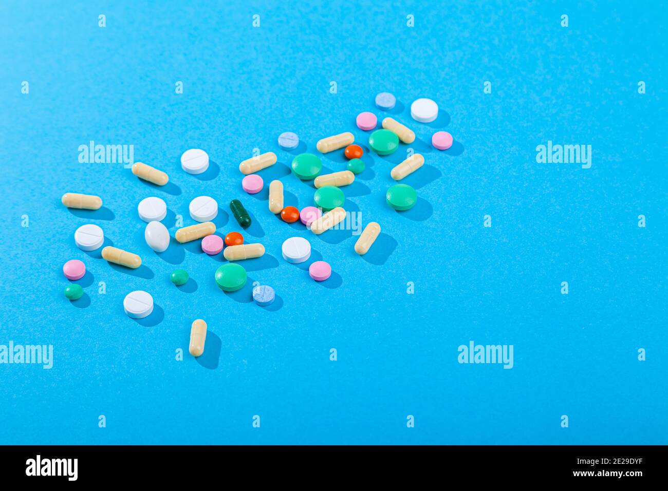 Many colored scattered pills and tablets, supplements for disease ...