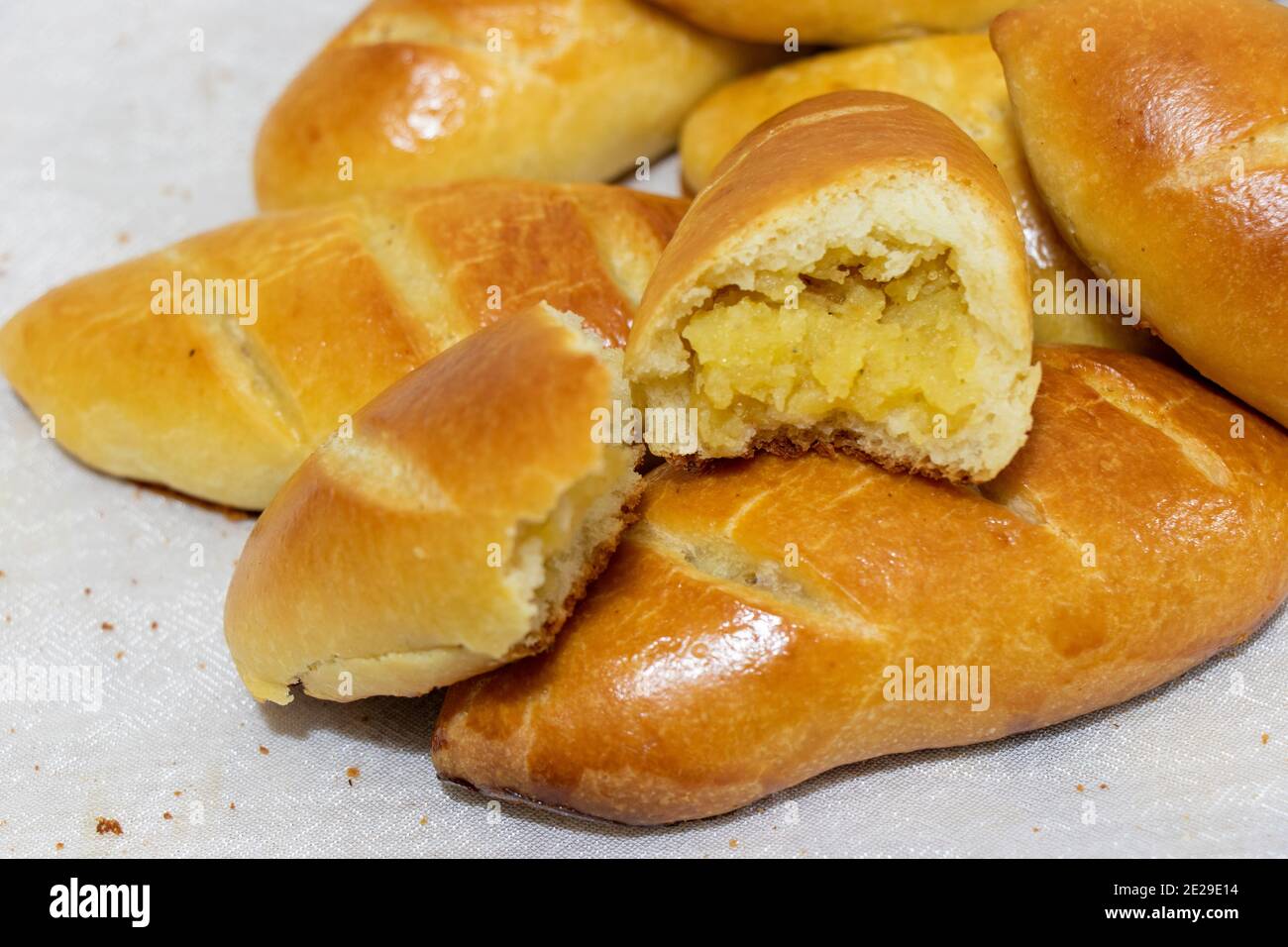 Freshly baked pies. Russian pies - piroshki with potatoes. Pirozhki ...