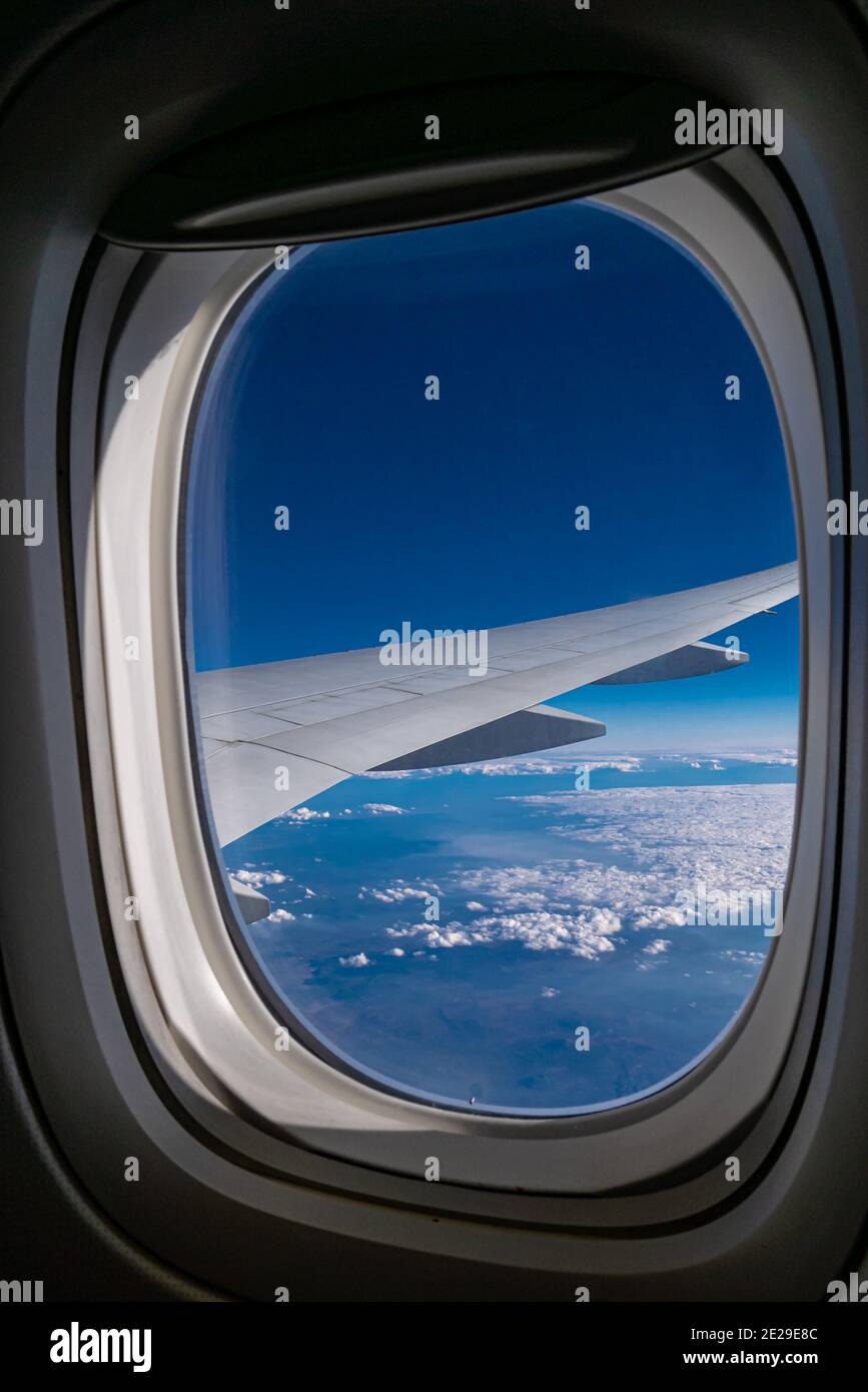 The airplane wing view from aeroplane window with beautiful atmosphere ...