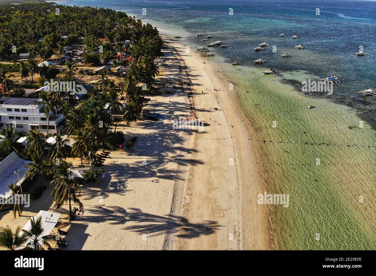 Amazing shot of the sandy beach and busy harbor on a sunny day - created by dji camera Stock ...