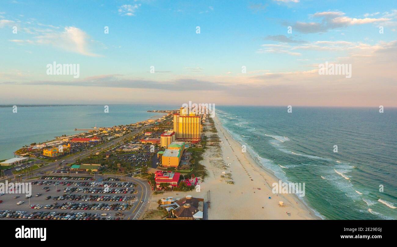 Aerial shot of sandy beach and the coastal buildings surrounded with ...
