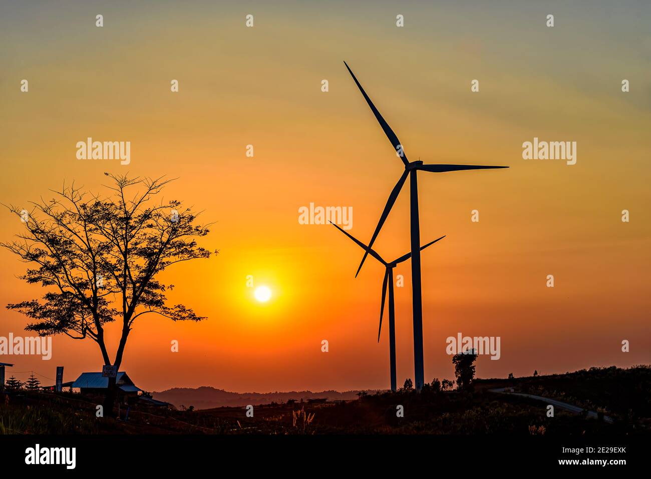 Wind turbine farm over sunset sky Generating Electricity. Renewable ...