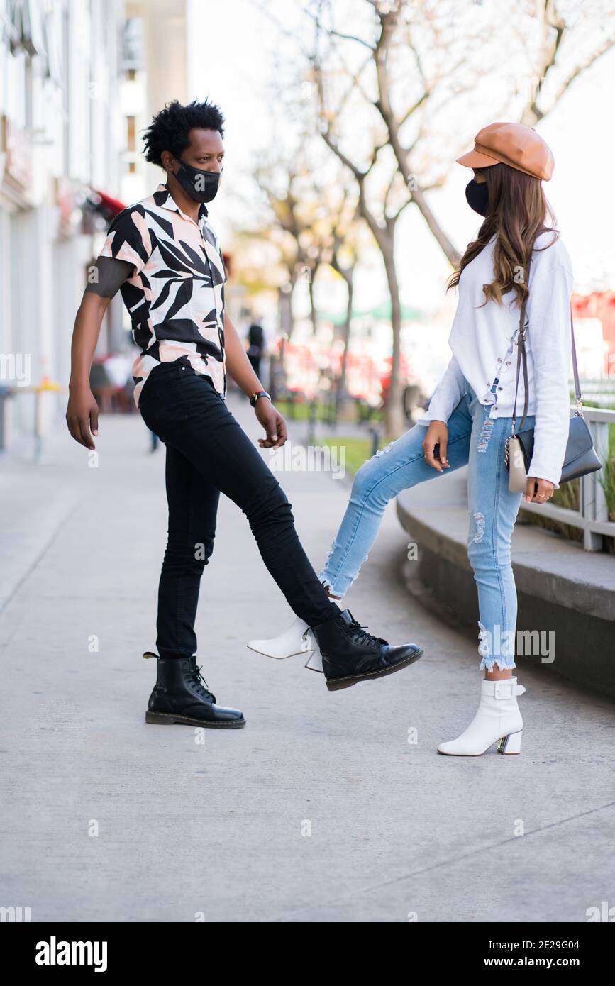 Couple tap each other with elbows to say hello Stock Photo - Alamy