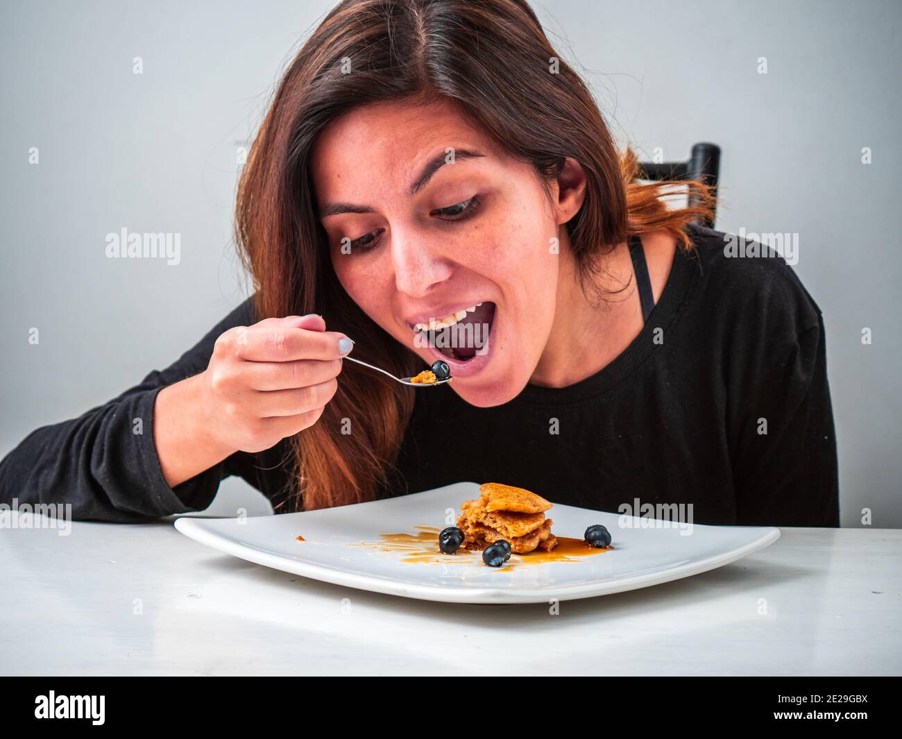 Latin Woman Eating Pancakes Stock Photo - Alamy