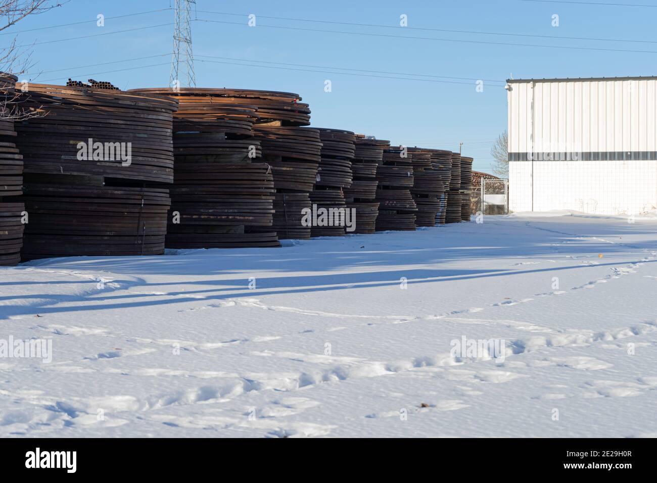 Stack of metal coils stored outside for manufacturing Stock Photo - Alamy