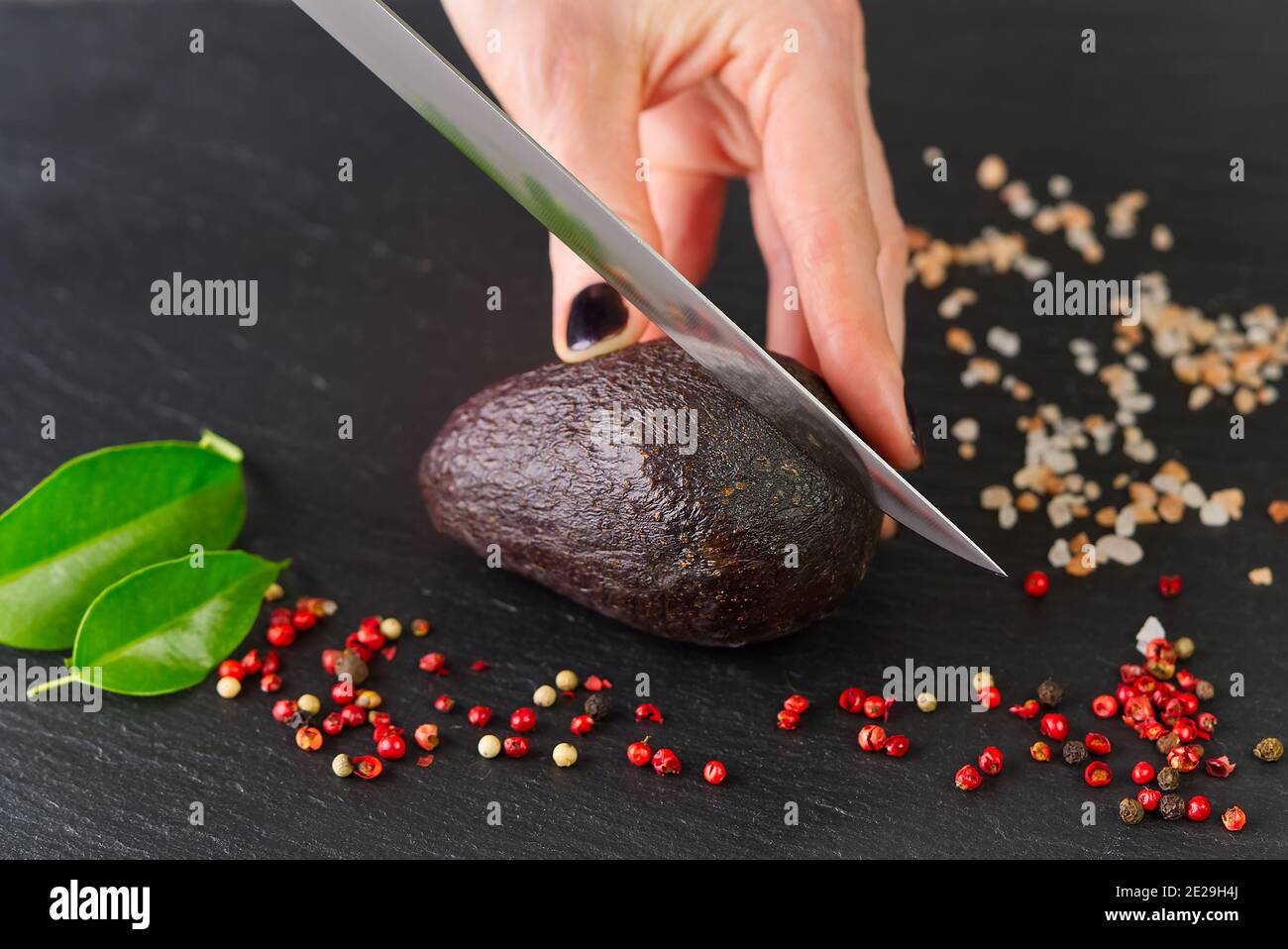 Black hands slicing up green hi-res stock photography and images - Alamy