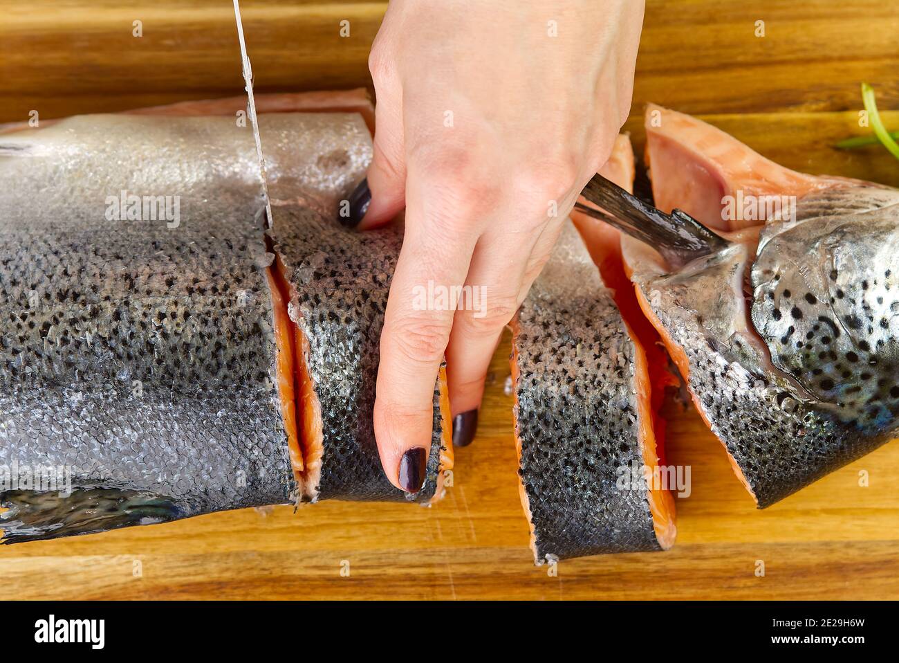 Cutting salmon fresh fish for dinner. diy cooking at home Stock Photo ...