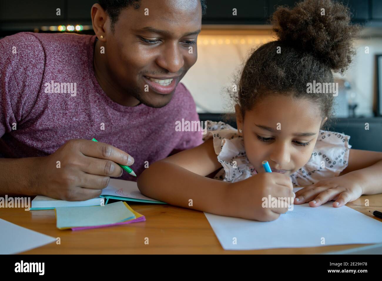 Father helping daughter homeschool hi-res stock photography and images ...