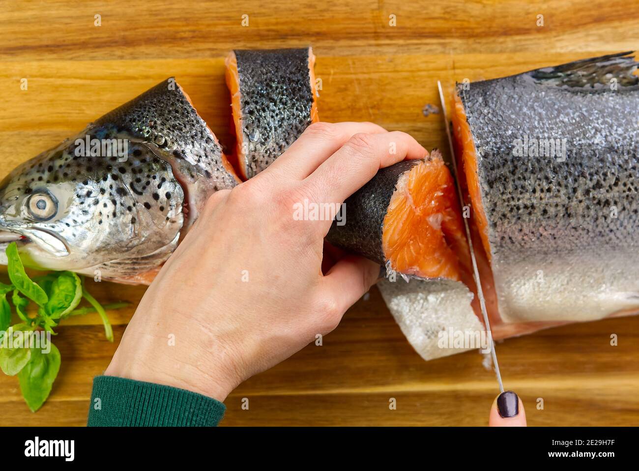 Cutting salmon fresh fish for dinner. diy cooking at home Stock Photo ...
