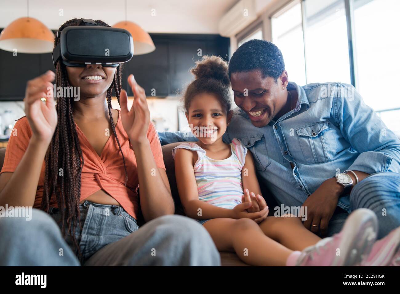 Family playing video games with VR glasses Stock Photo - Alamy