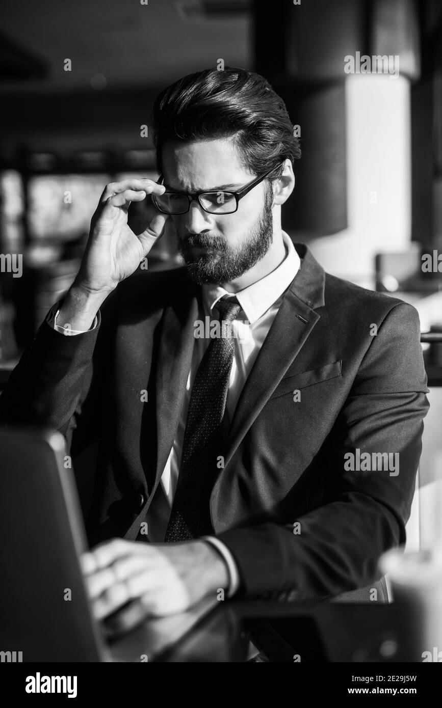 Male executive looking laptop Black and White Stock Photos & Images - Alamy