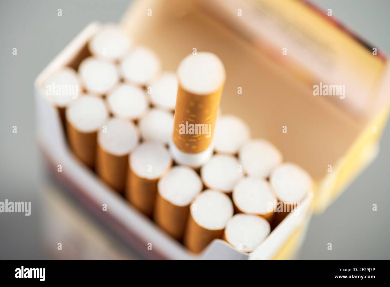 Open pack of cigarettes with one stretched out cigarette close-up Stock ...
