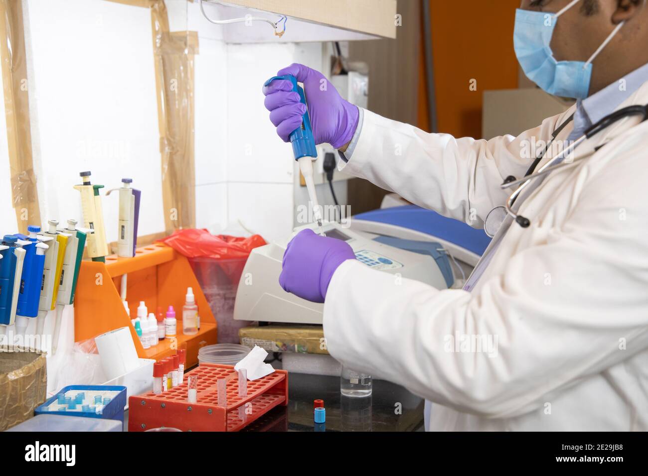 Indian medical scientist doctor wearing surgical face mask doing ...
