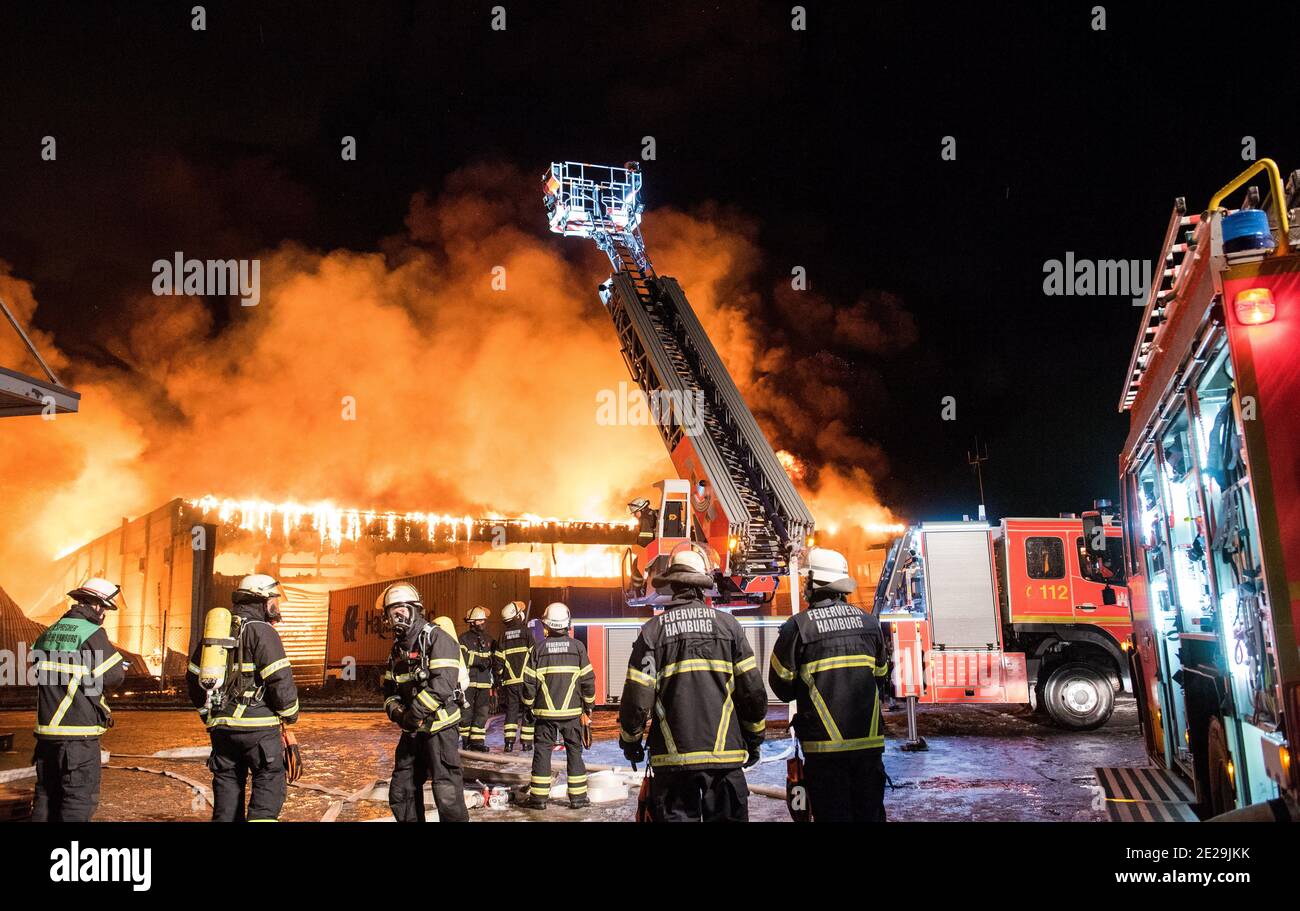 Hamburg, Germany. 13th Jan, 2021. Firefighters extinguish a major fire ...