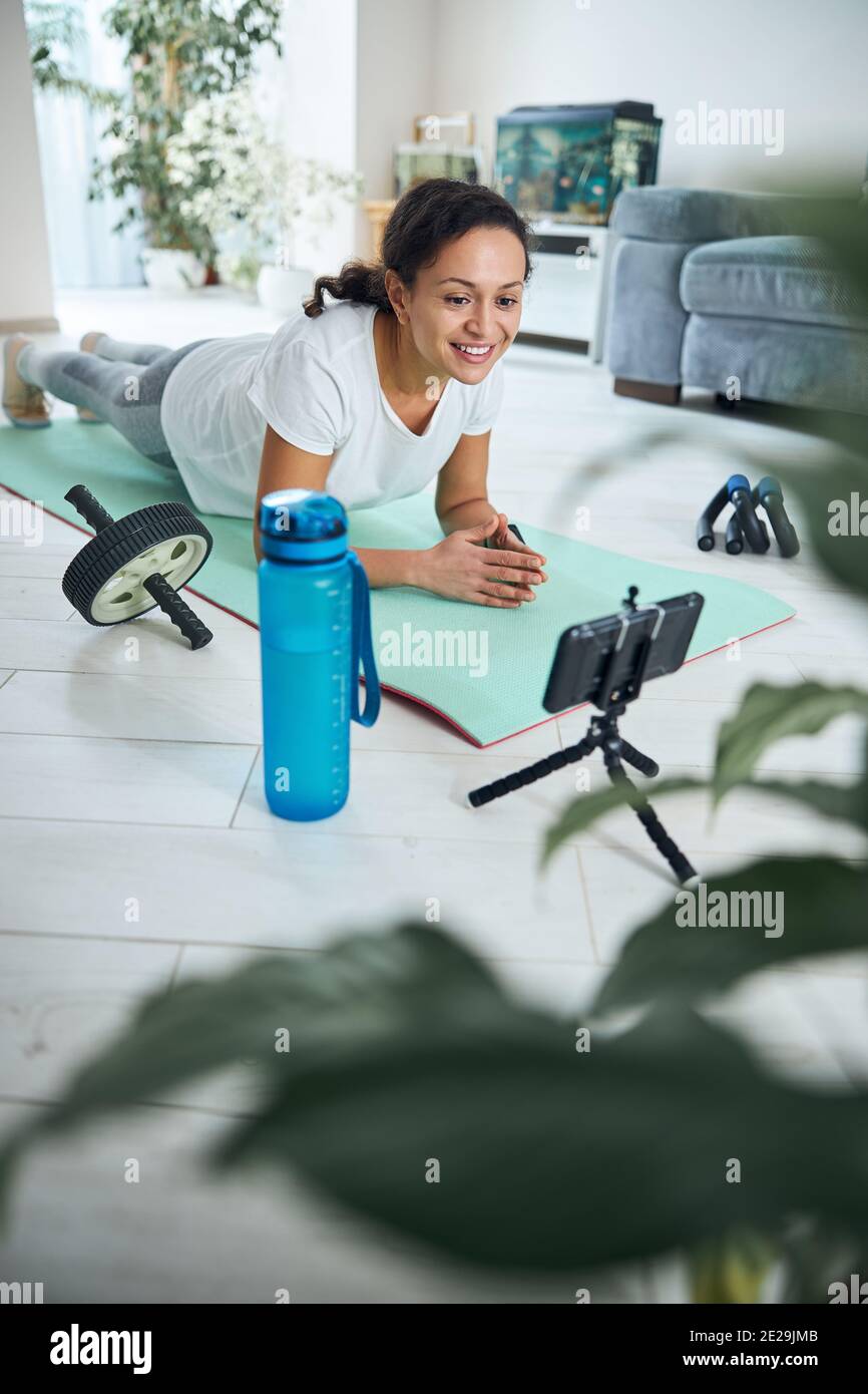 Smiling cute vlogger performing the plank exercise Stock Photo - Alamy