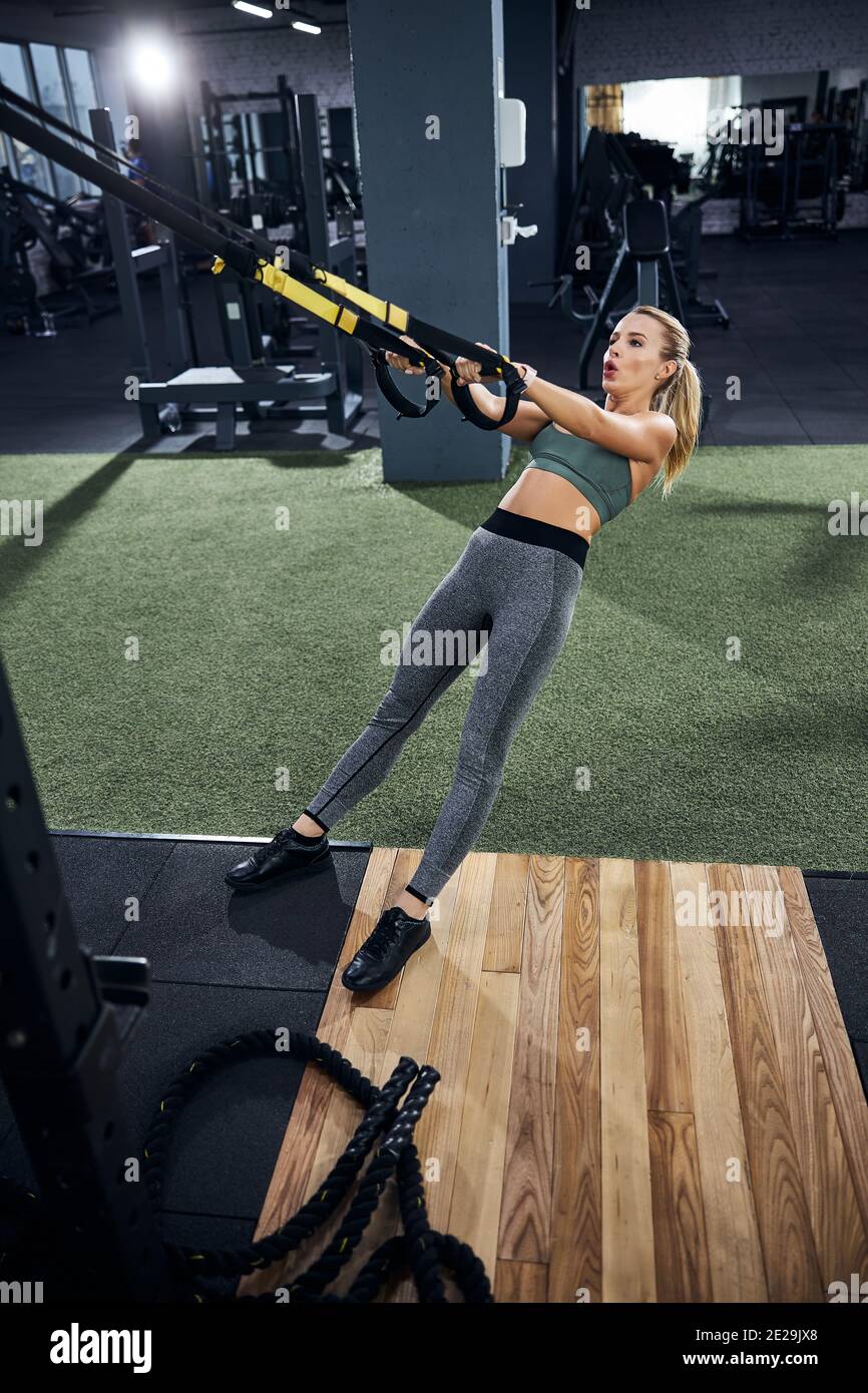 Woman throwing her body back while grabbing the ropes Stock Photo - Alamy